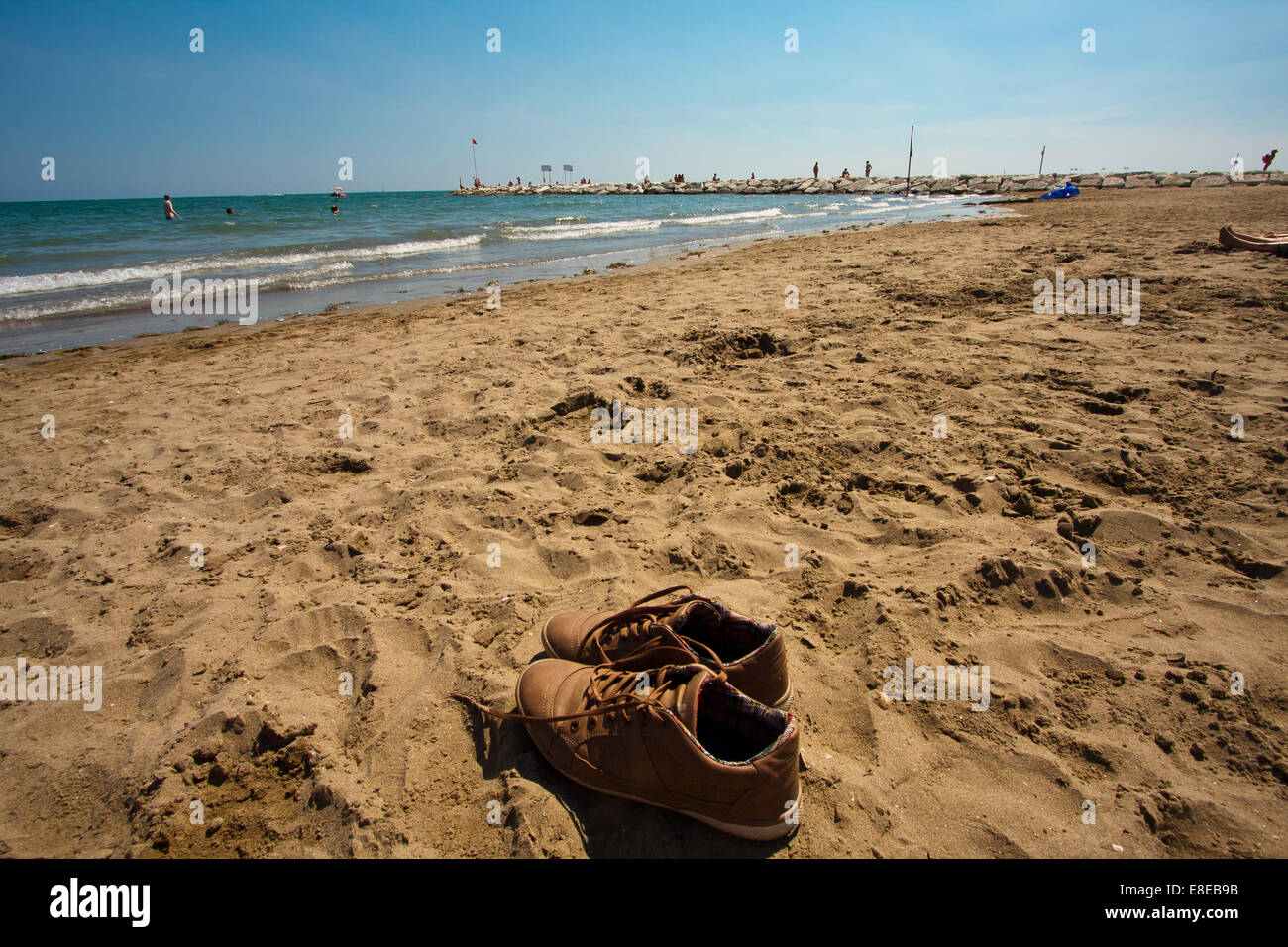 Shoes on a sandy beach Stock Photo - Alamy