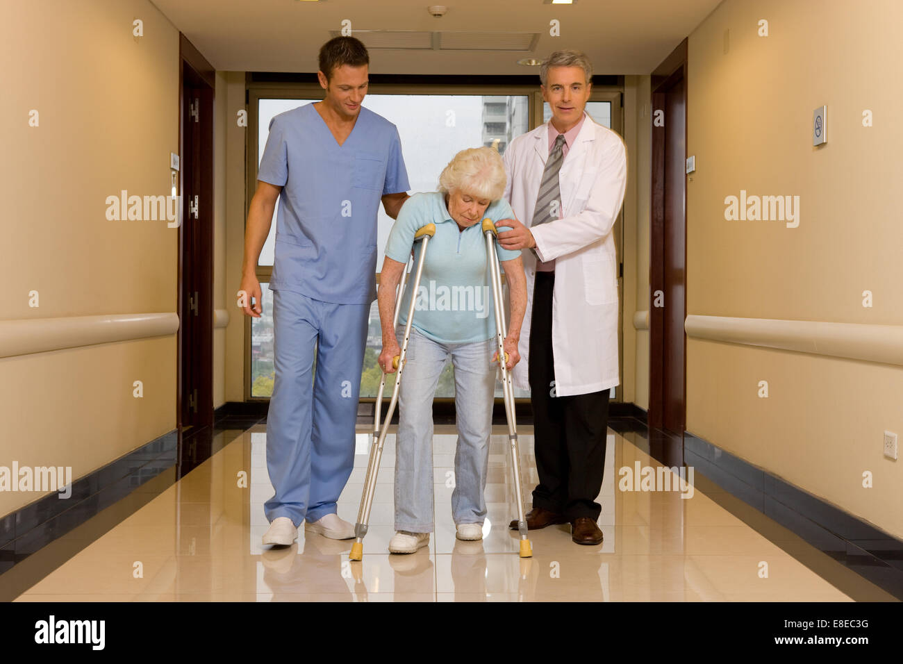 Helping an old lady to walk Stock Photo - Alamy