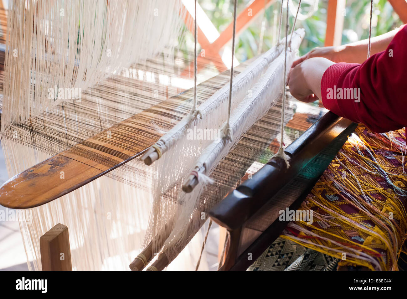 Woman weaving silk in traditional way at manual loom. Laos Stock Photo ...