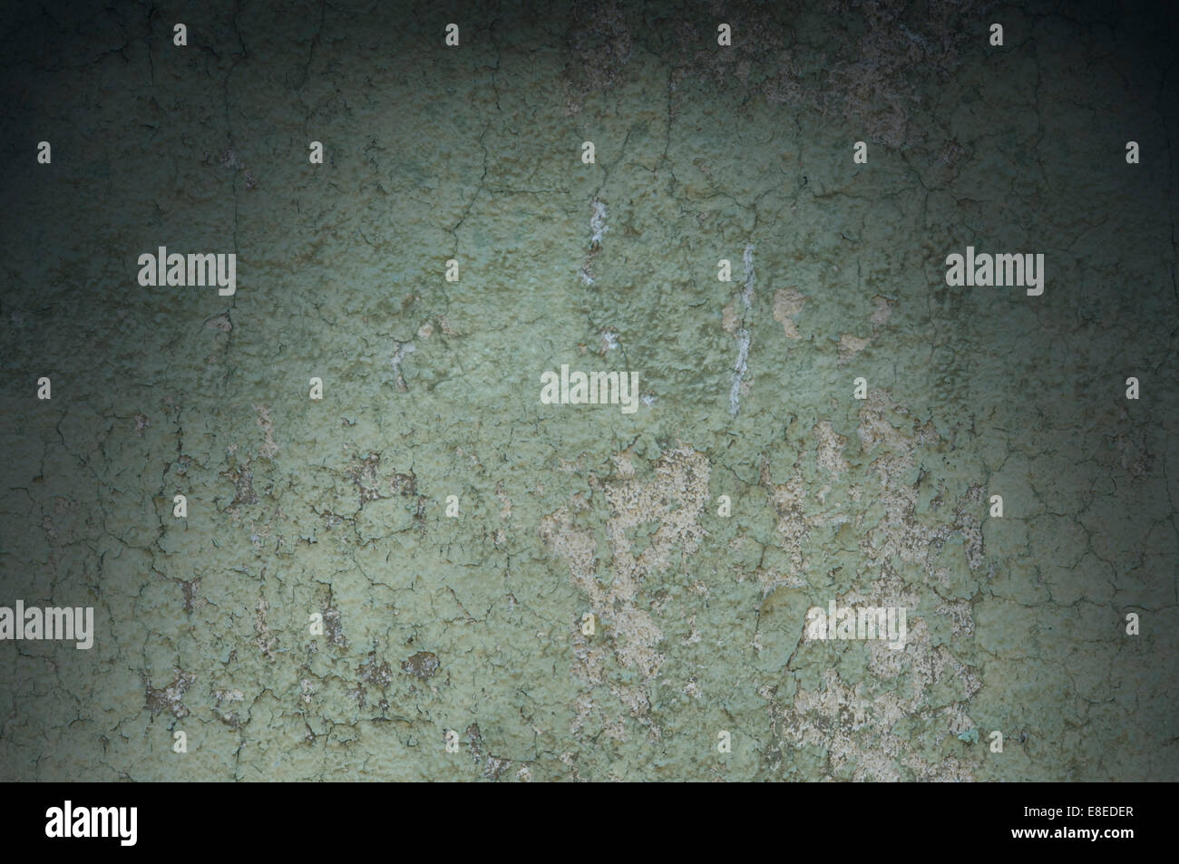 Grayish green weathered and distressed textured background wall, lit ...