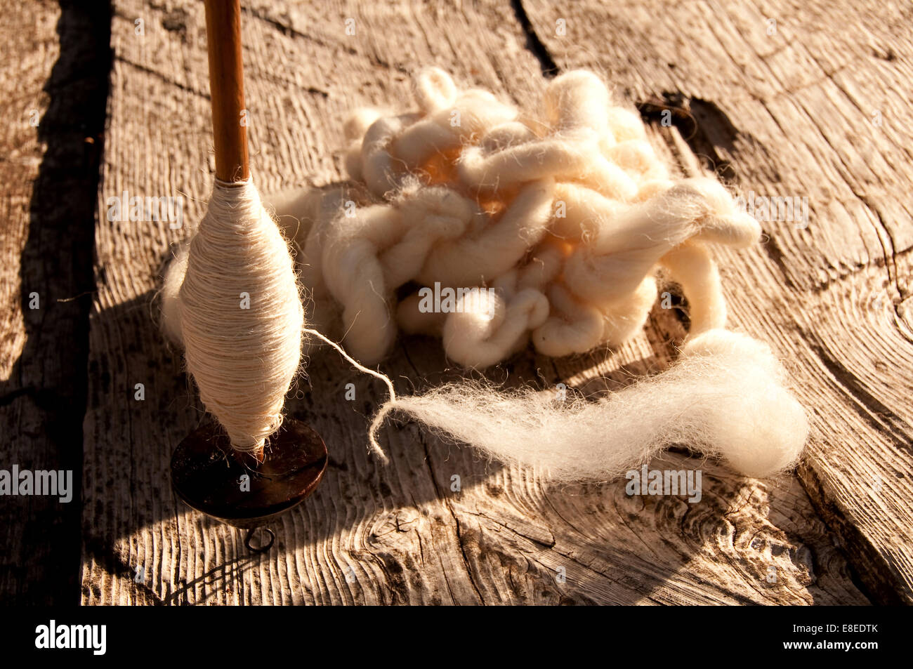 Old wool spindle and virgin wool Stock Photo - Alamy