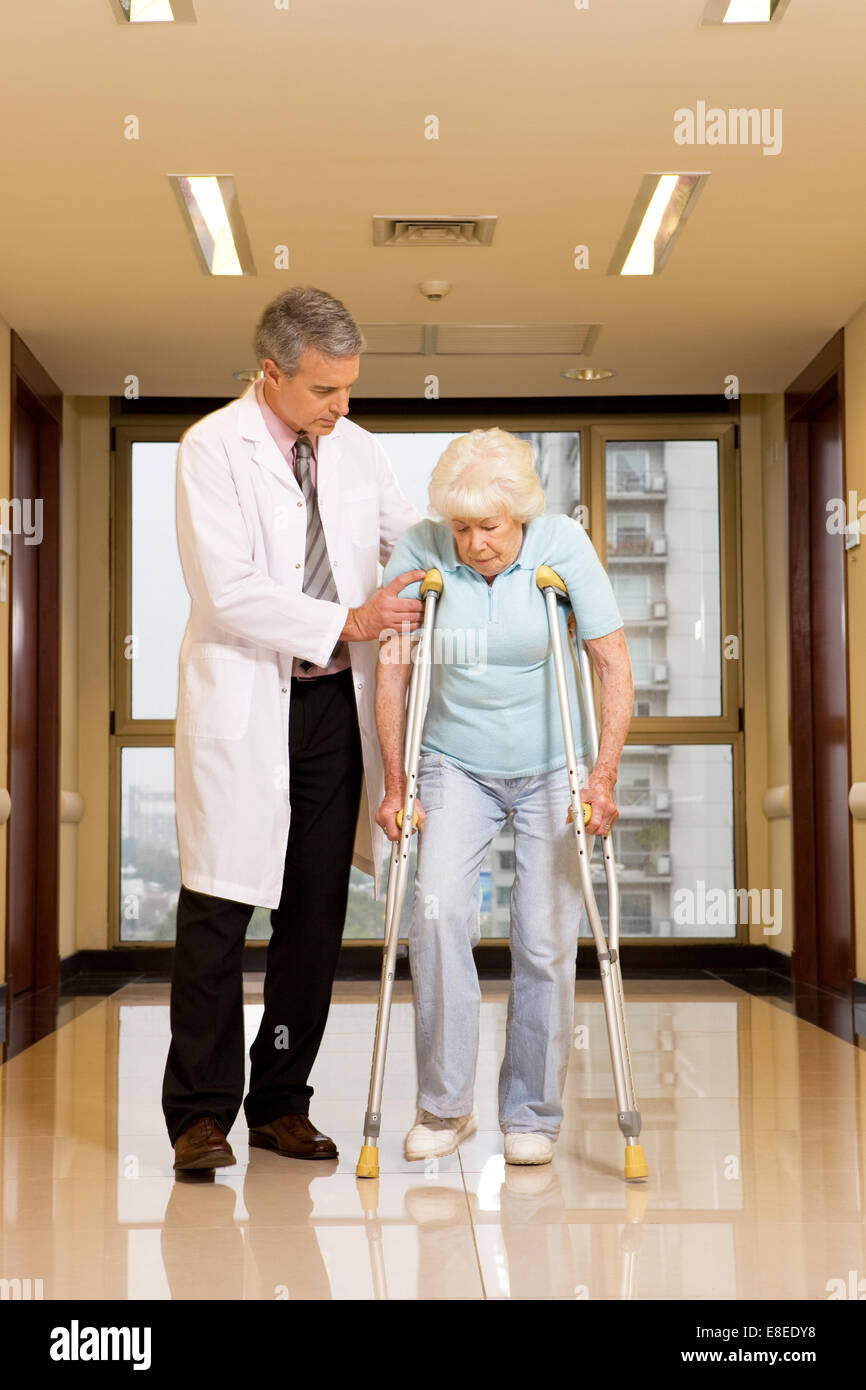 Doctor helping a patient Stock Photo - Alamy