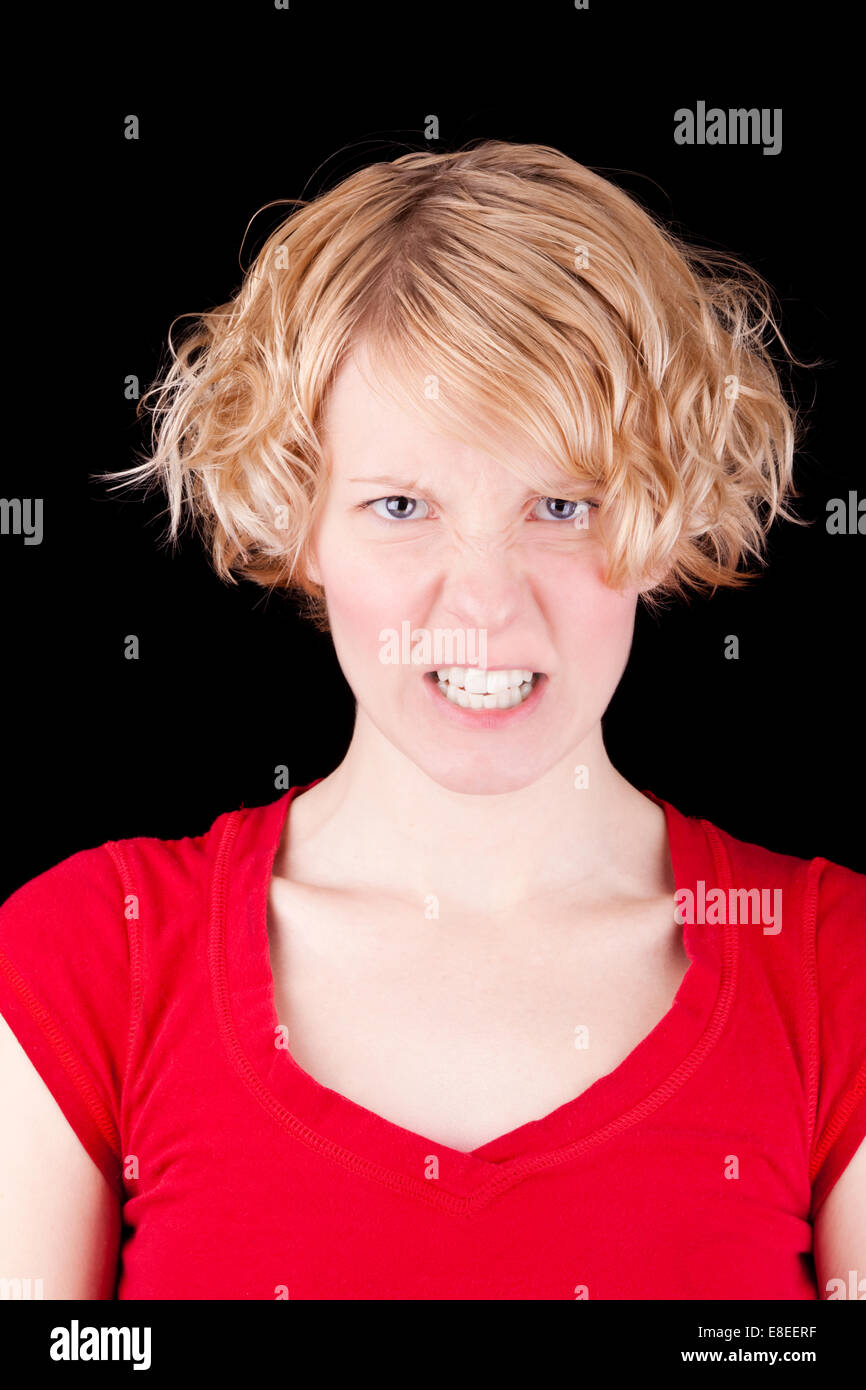 Very angry girl isolated on black background Stock Photo - Alamy
