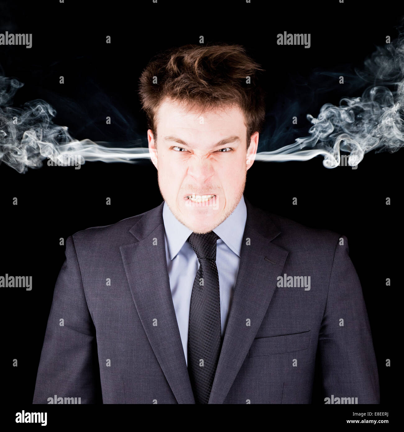 Portrait of a furious businessman isolated on black Stock Photo - Alamy