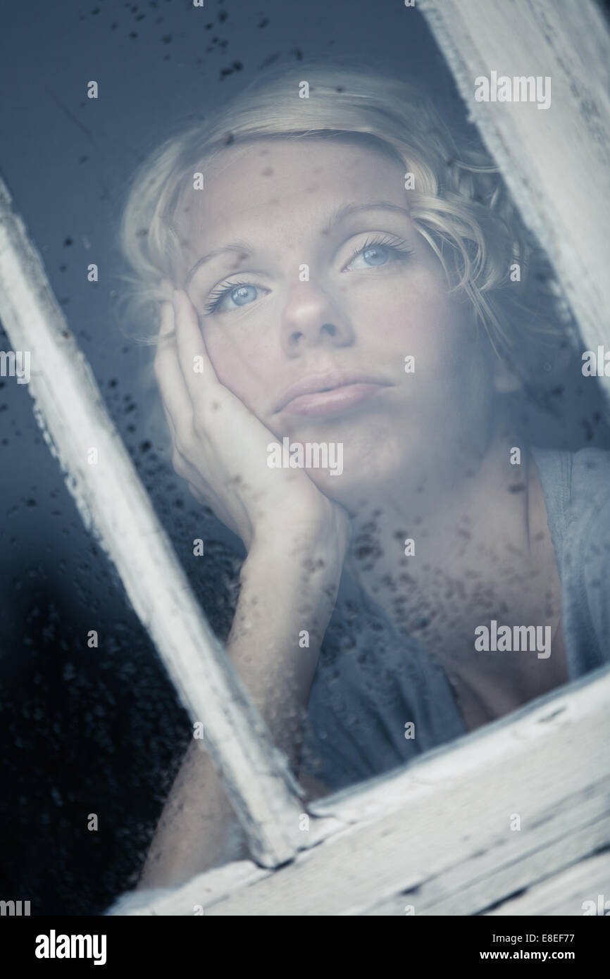 Bored Woman Looking at the Rainy Weather By the Window Frame Stock ...