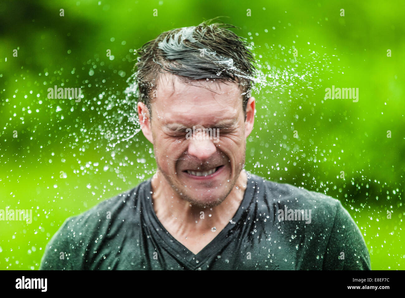 Young Adult Completely Drenched Shaking His head and Making a Funny ...