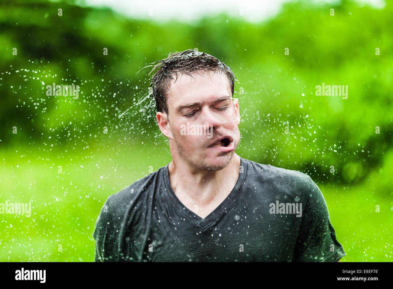 Young Adult Completely Drenched Shaking His head and Making a Funny ...