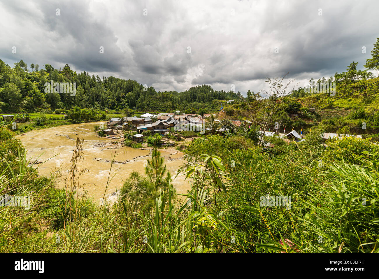 Traditional village on a river bank in the remote Mamasa Valley, West ...