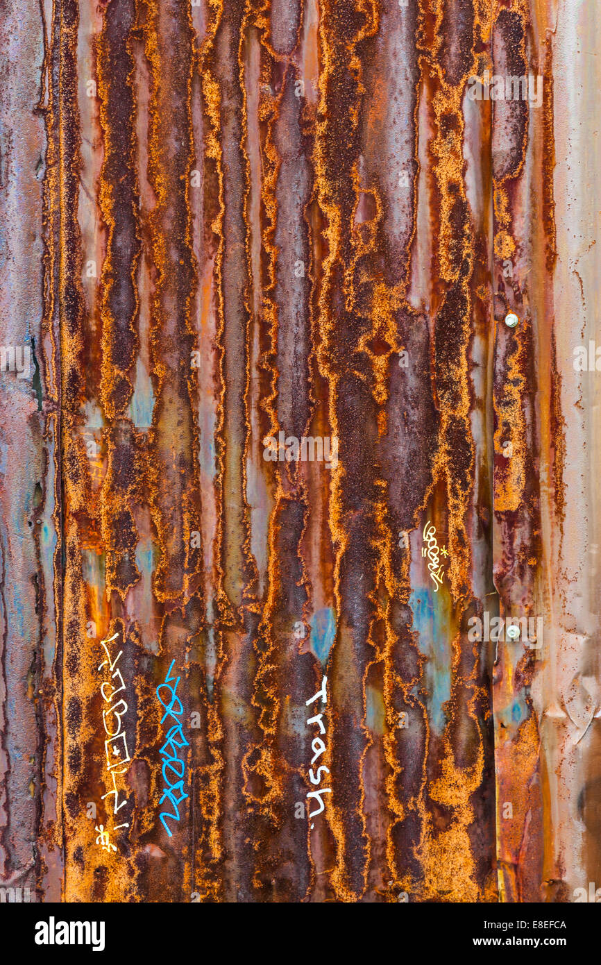 Corroded corrugated metal siding with minor graffiti Stock Photo - Alamy
