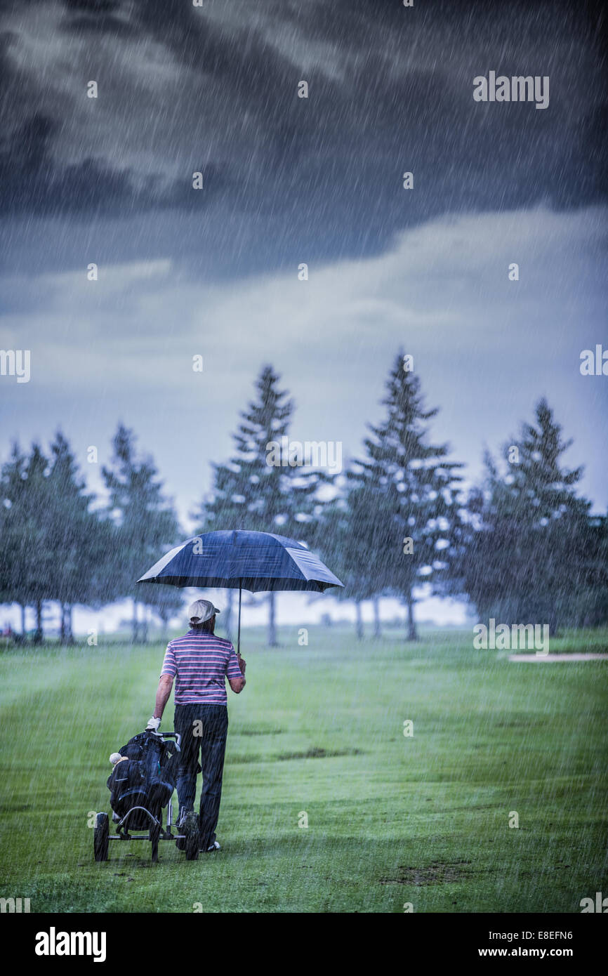 Golfer on a Rainy Day Leaving the Golf Course (the game is annulled ...