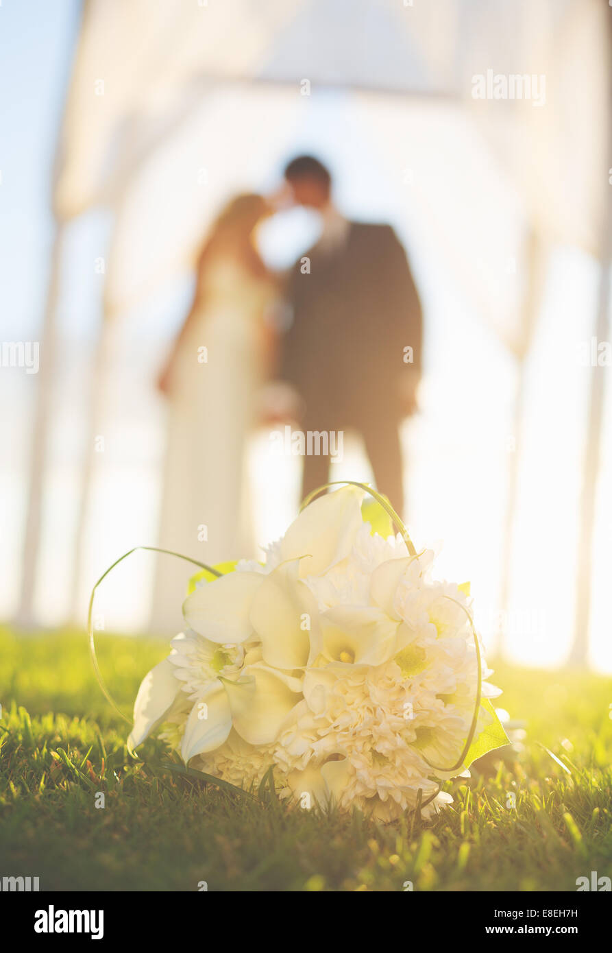 Close up of Wedding Bouquet. Focus on Flowers. Bride and Groom in ...