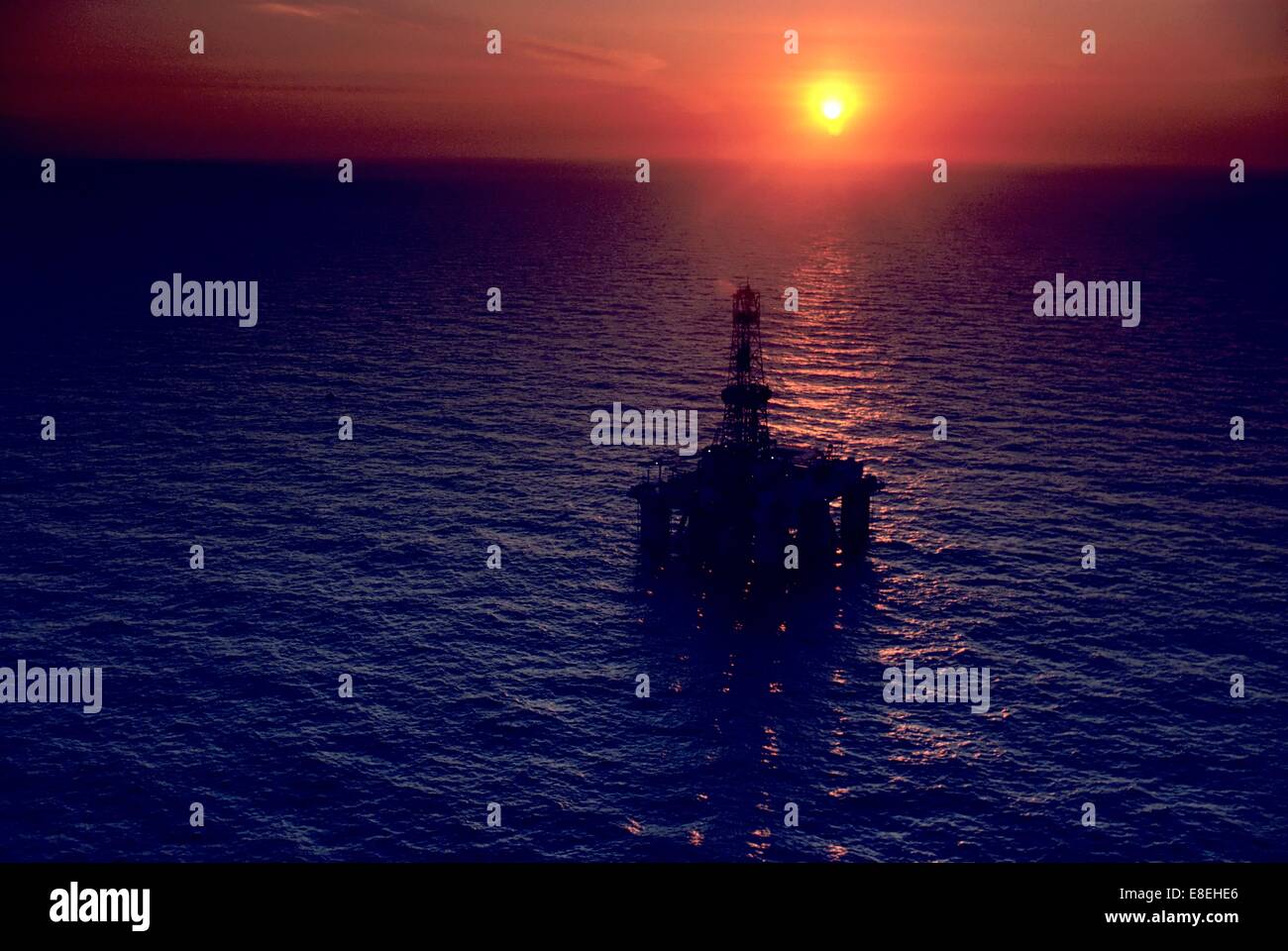 Offshore Oil Drilling Rig at Sunset Stock Photo - Alamy
