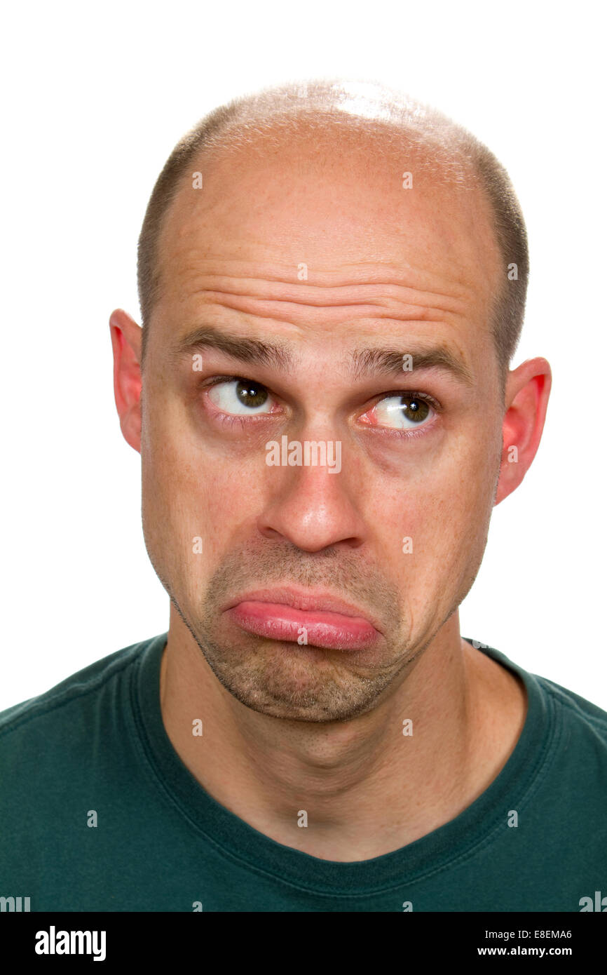 Man rolls his eyes looking upward and thrusts his lips out as he sadly ...