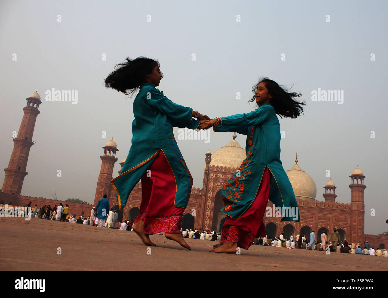 Lahore, Pakistan. 6th October, 2014. Pakistani Muslim devotees hug each ...