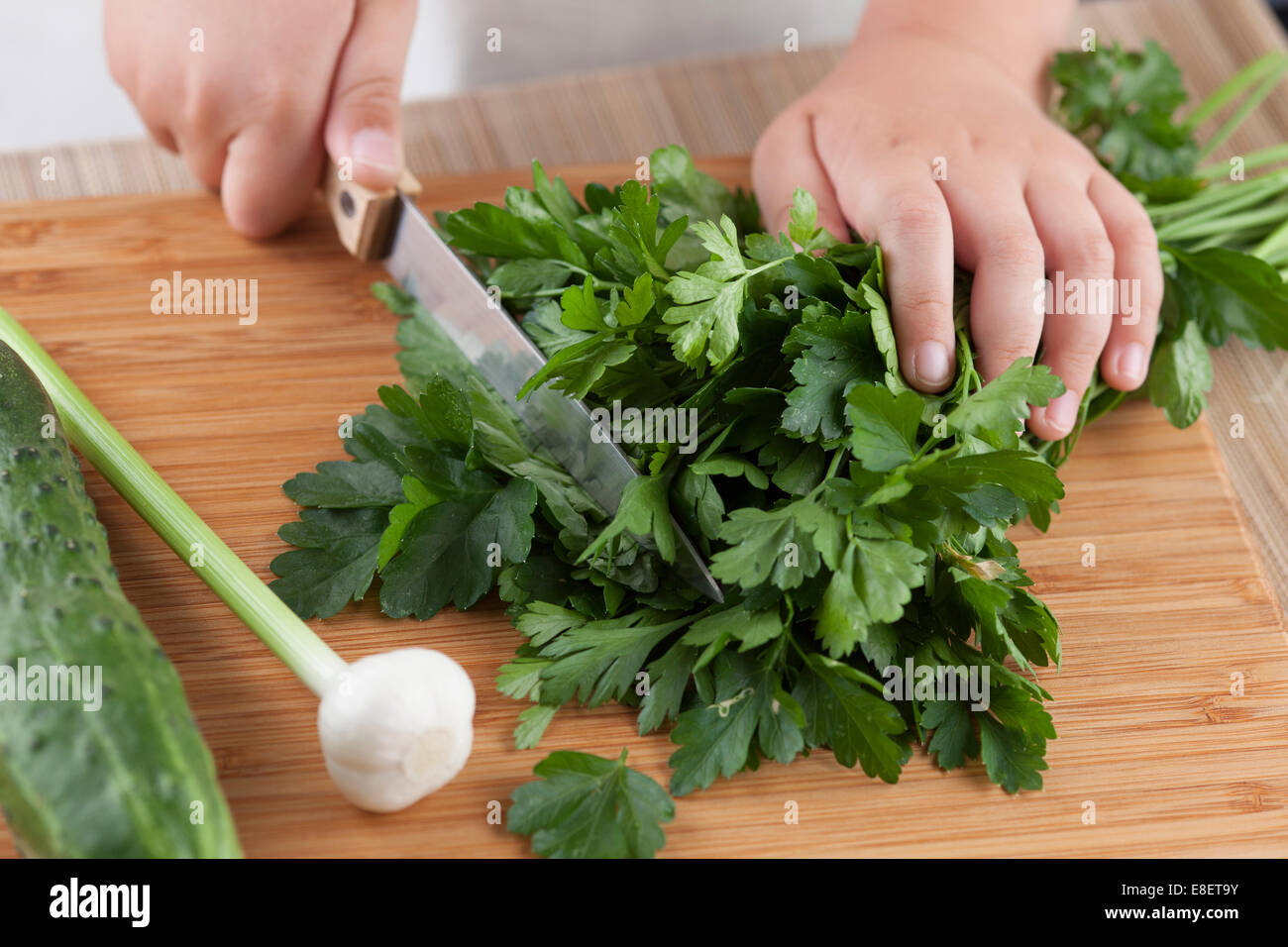 Child's hands cutting parsley Stock Photo - Alamy