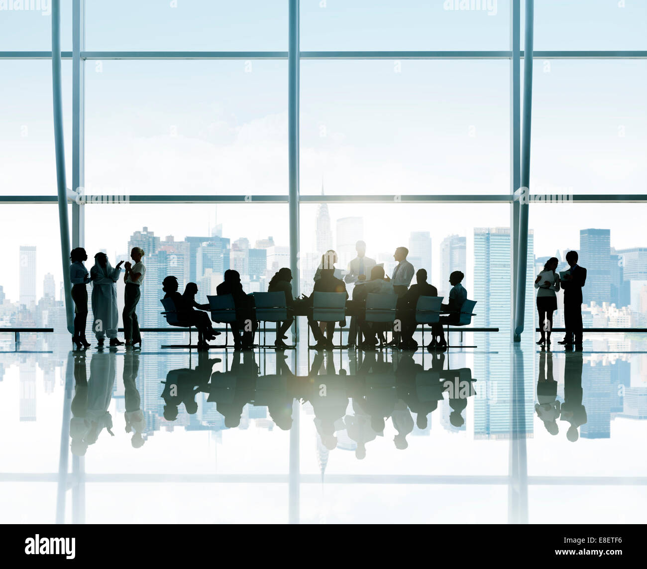 Silhouettes of business people around the conference table with a view ...