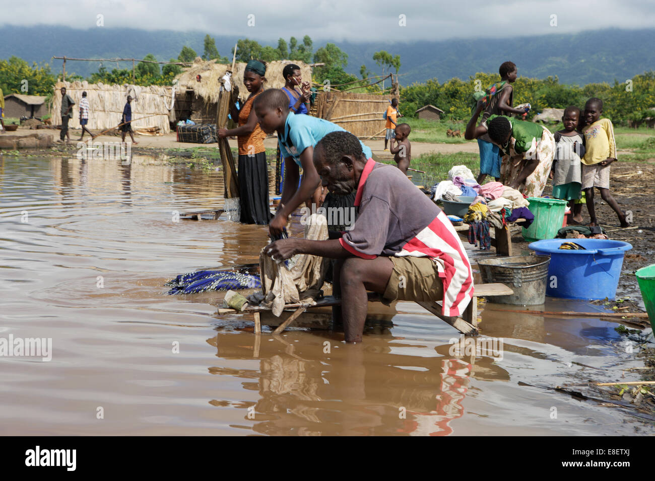 Men and women wash their clothes on the banks of the Zambezi River. The ...
