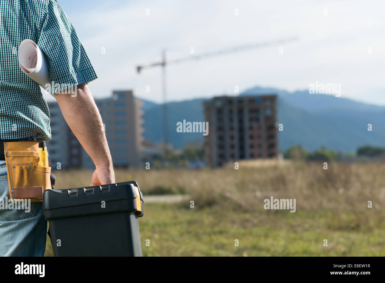 closeup, back view of male engineer standing on construction site ...