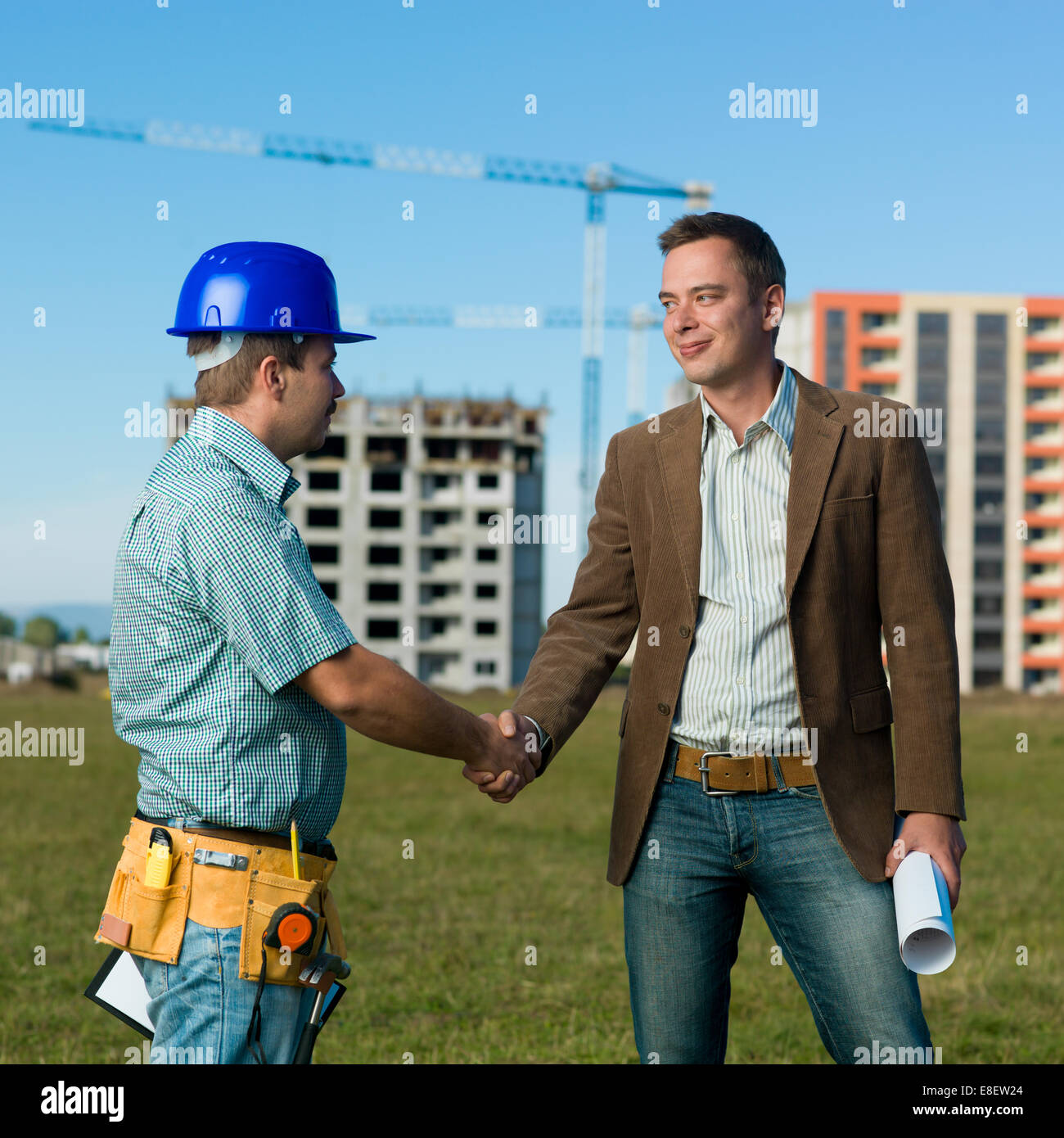 architect and construction engineer standing and shaking hands on ...