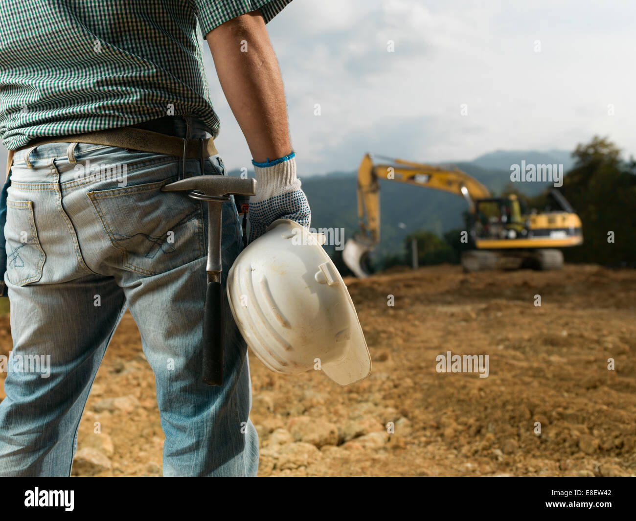 closeup back view of male engineer standing on construction site ...