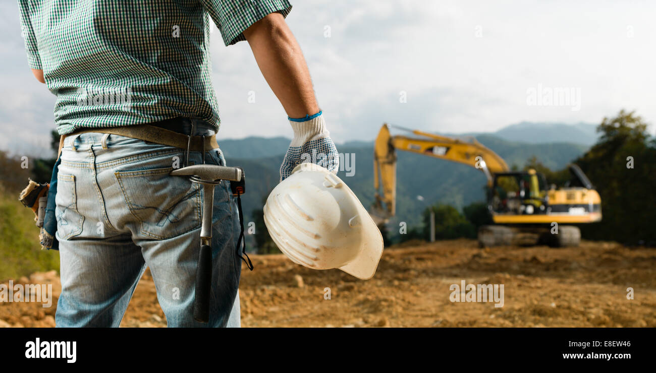 closeup back view of male engineer standing on construction site ...