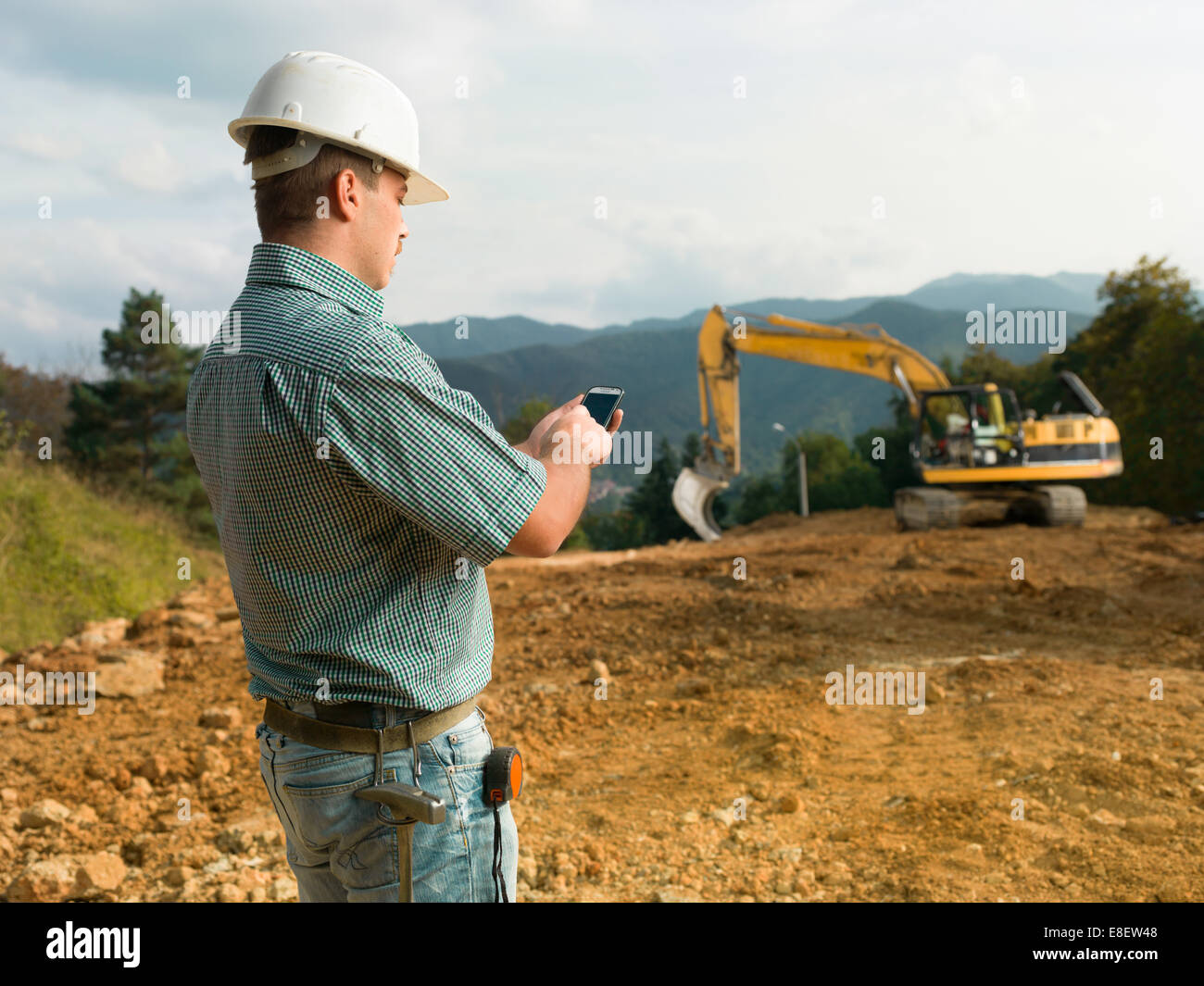 Construction worker looking at phone hi-res stock photography and ...
