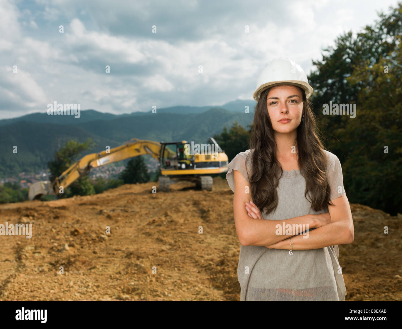 portrait of young caucasian female engineer on construction site with ...