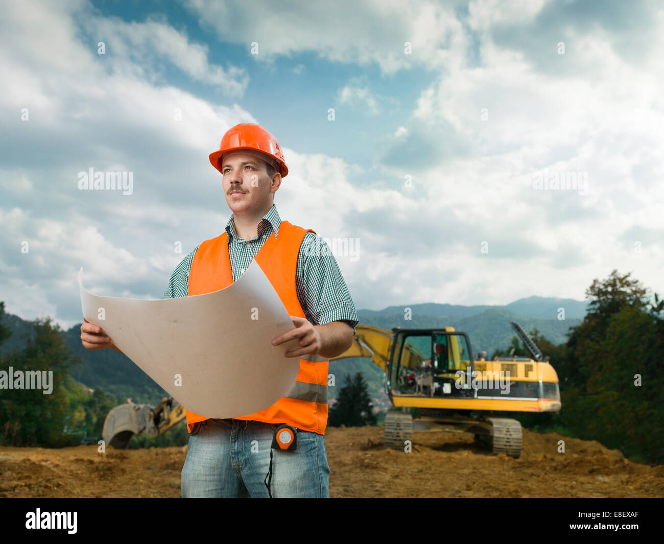 front view of engineer on construction site holding plan Stock Photo ...