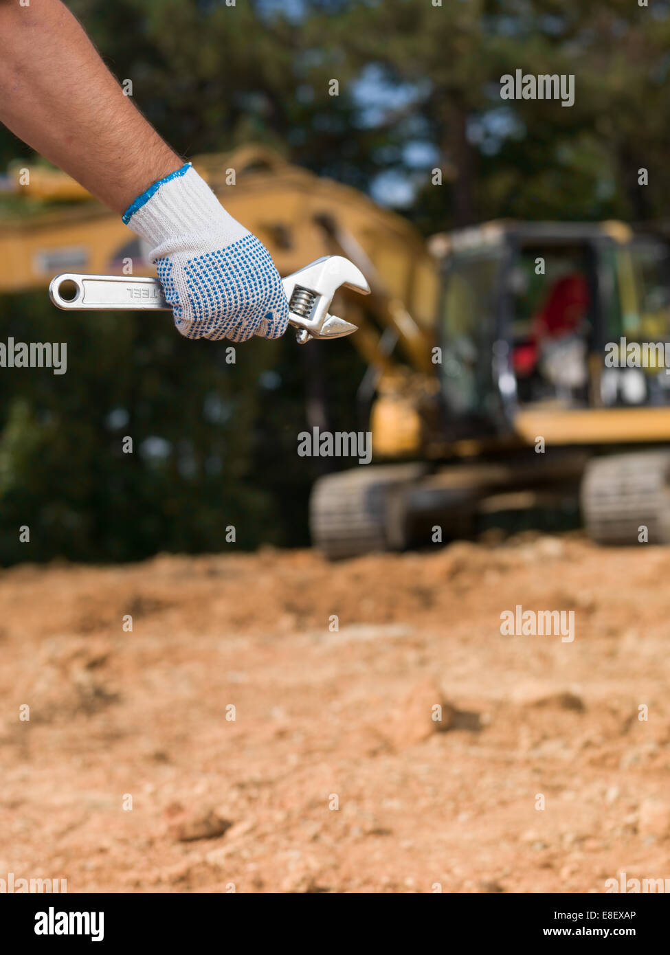 closeup of male engineer hand holding french wrench on construction ...
