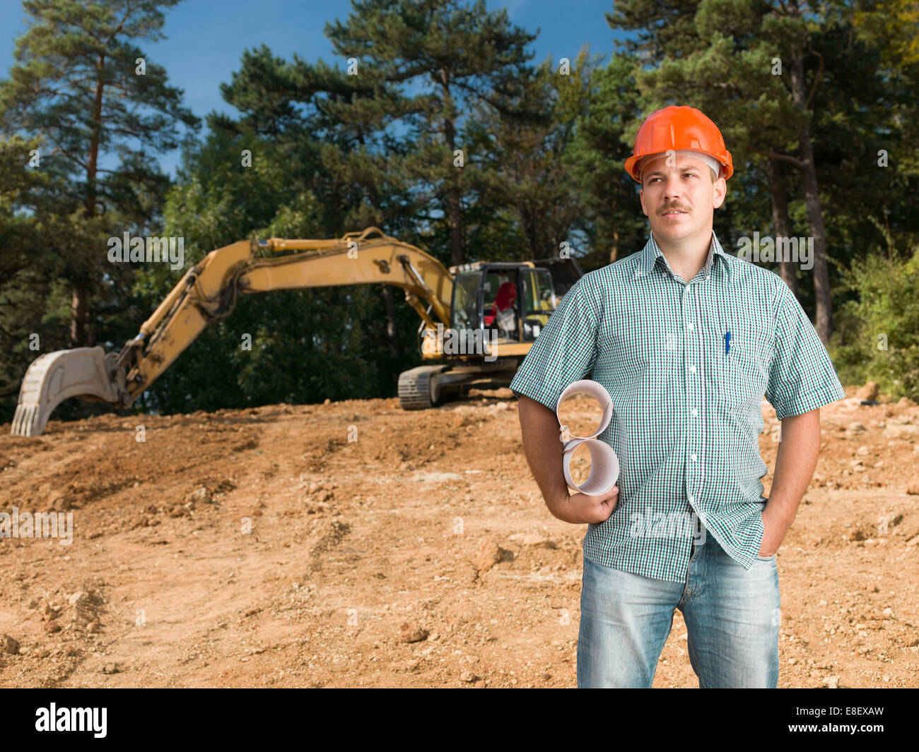 front view of architect on construction site holding blueprints Stock ...