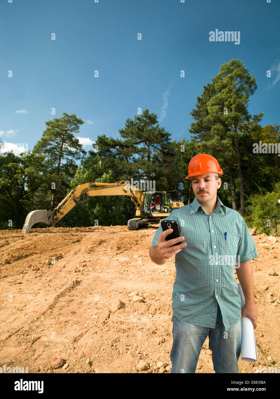 Construction worker looking at phone hi-res stock photography and ...