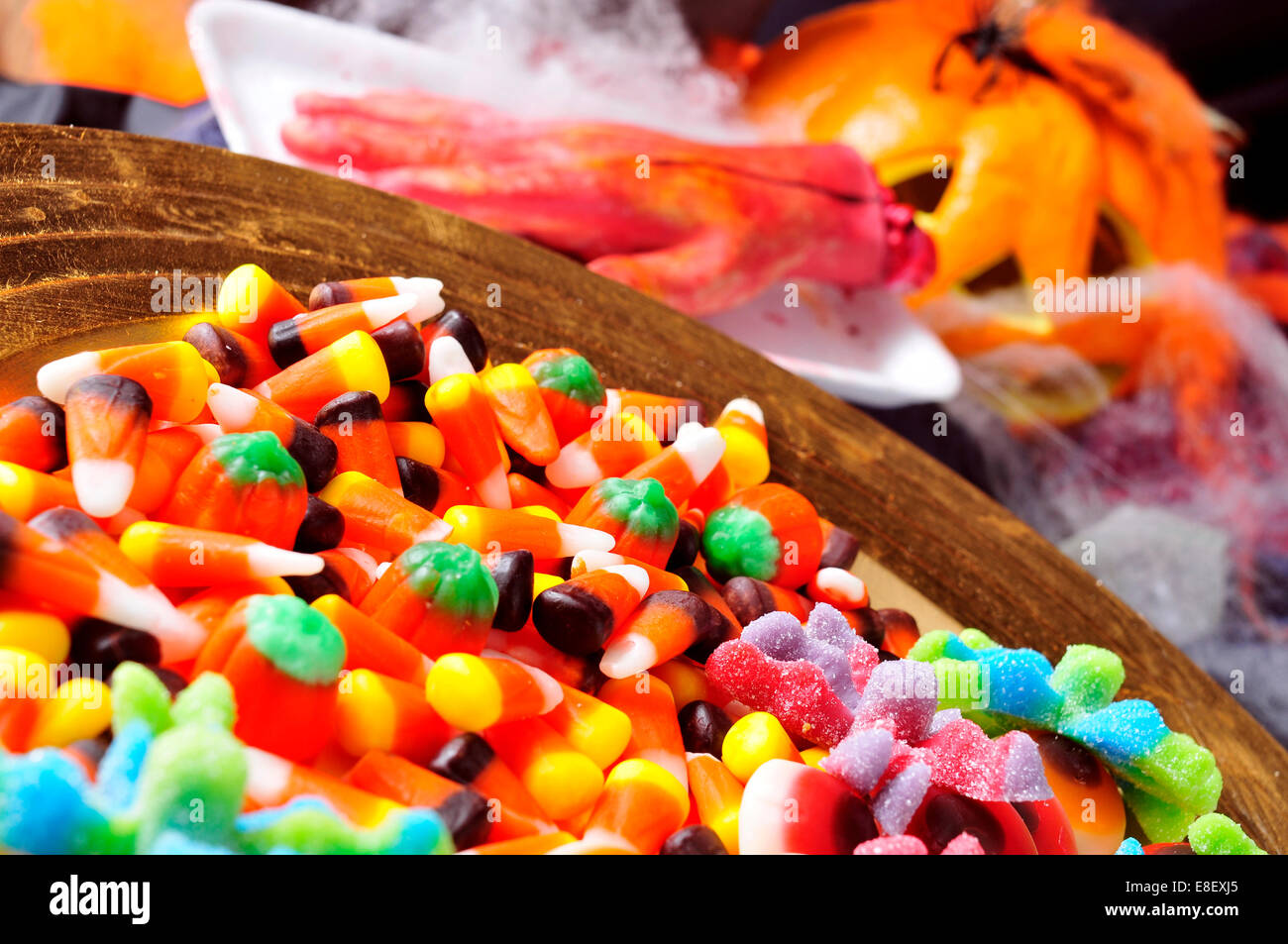 a pile of different Halloween candies with scary ornaments in the ...