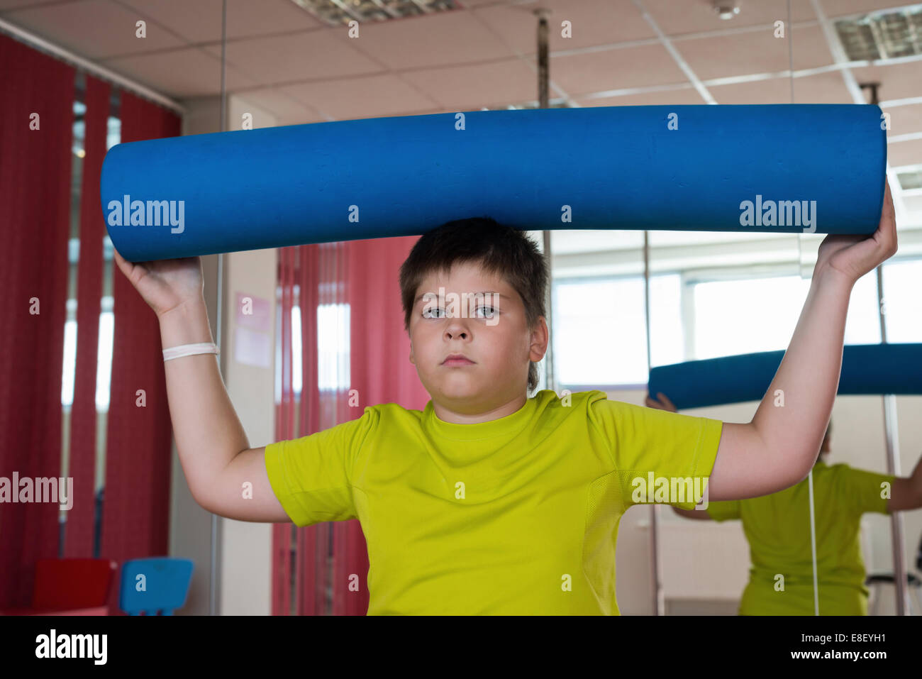 Boy does exercise in the gym Stock Photo - Alamy