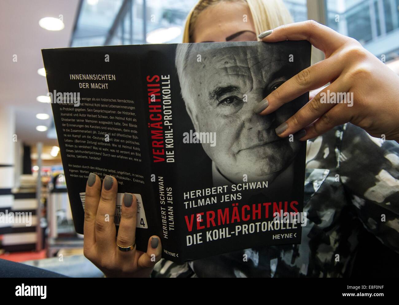 A woman holds a book written about the recording of conversation with ...