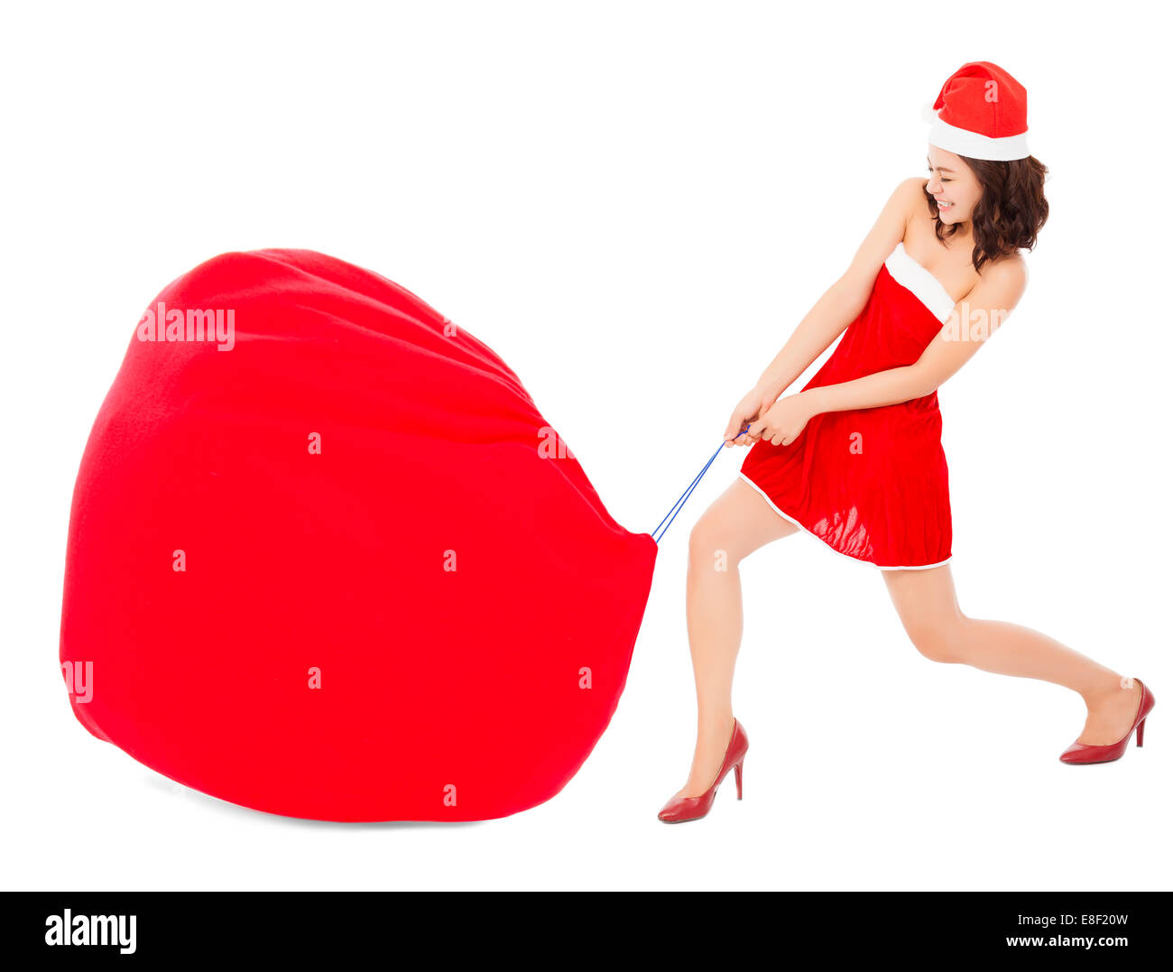 young female pulling a heavy and big gift bag over white background ...
