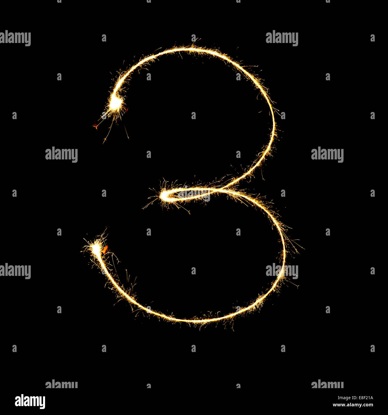 burning sparkler stick and writing sparkling text . number three ...