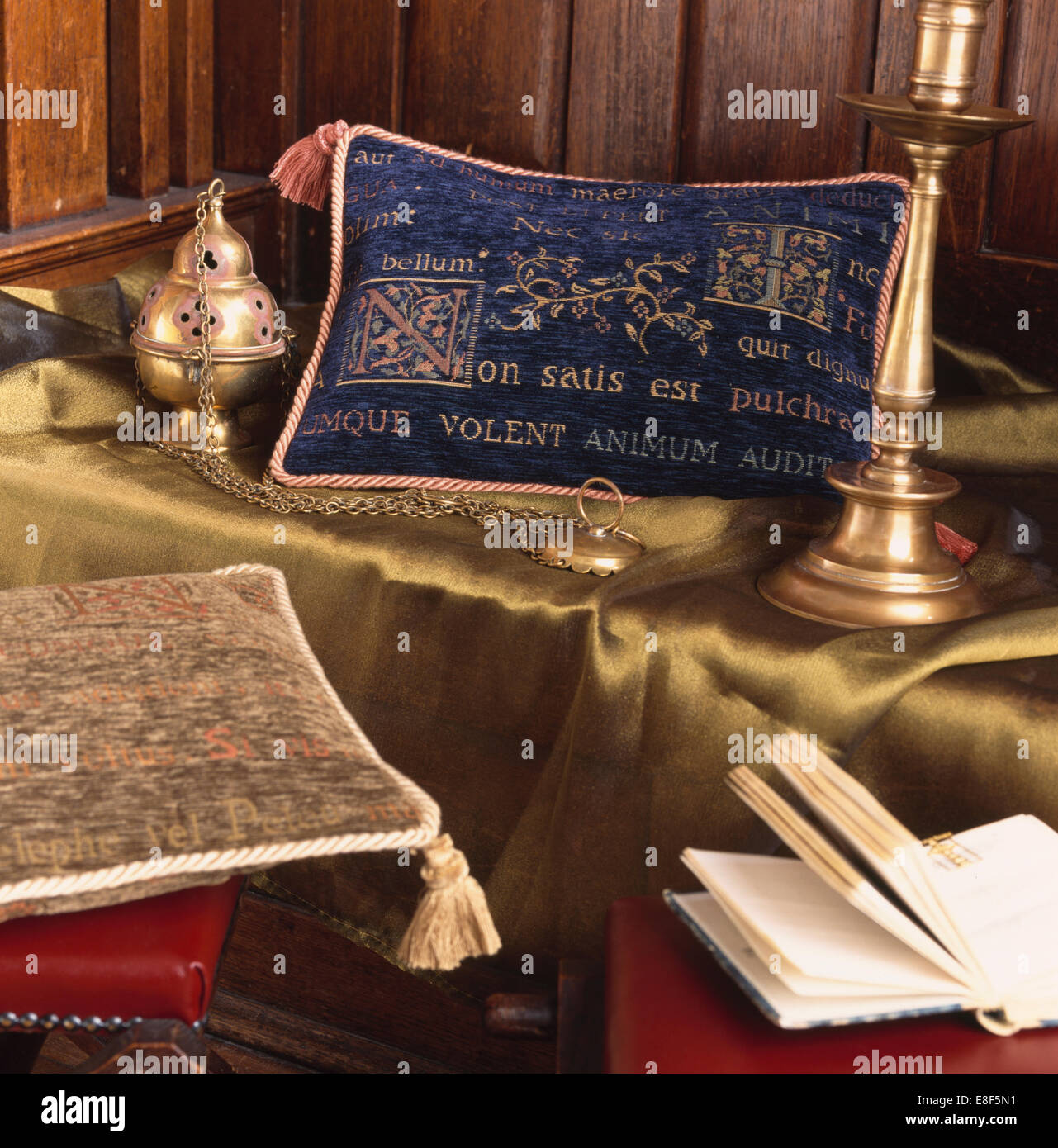 Close-up of velvet cushions with gold calligraphy on table with a satin ...