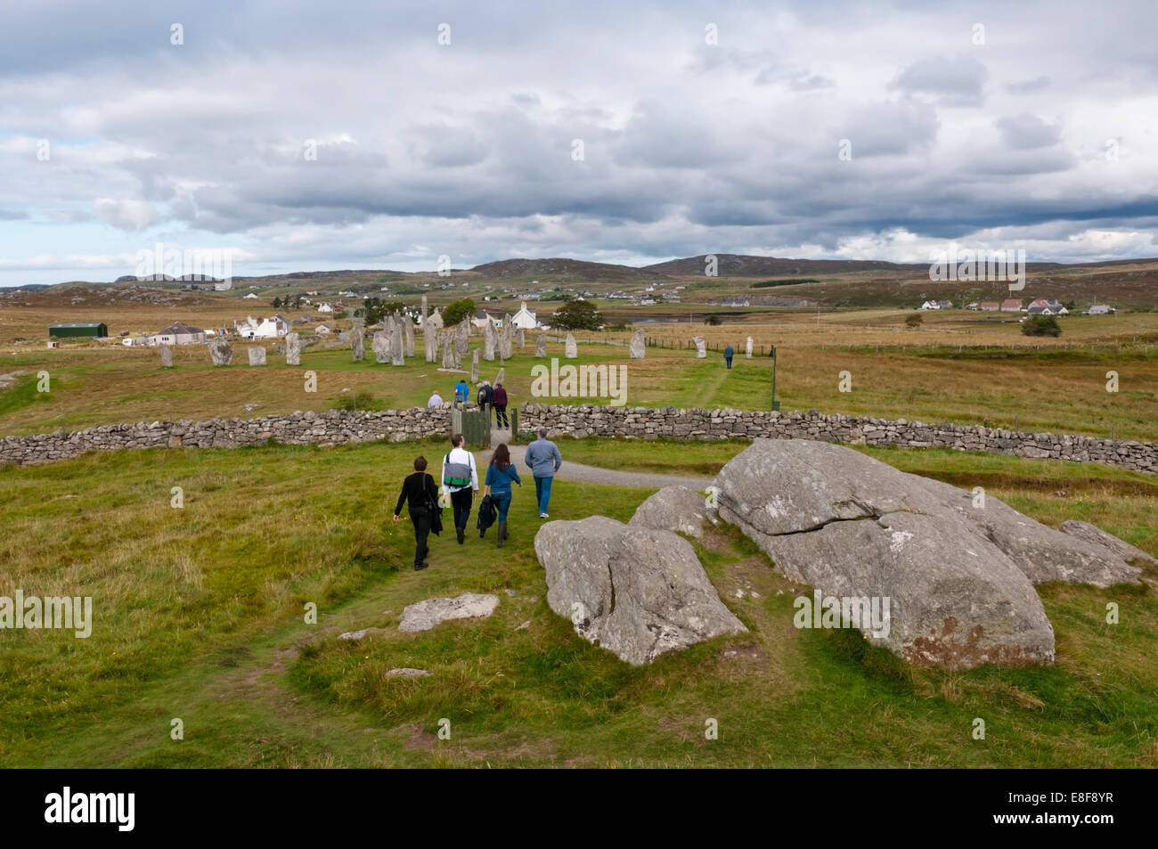 Visitors to the Callanish standing stones on the Isle of Lewis in the ...