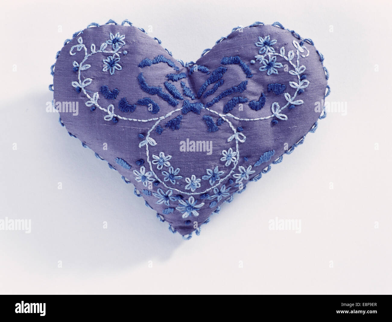 Close-up of embroidered blue silk heart decoration Stock Photo - Alamy
