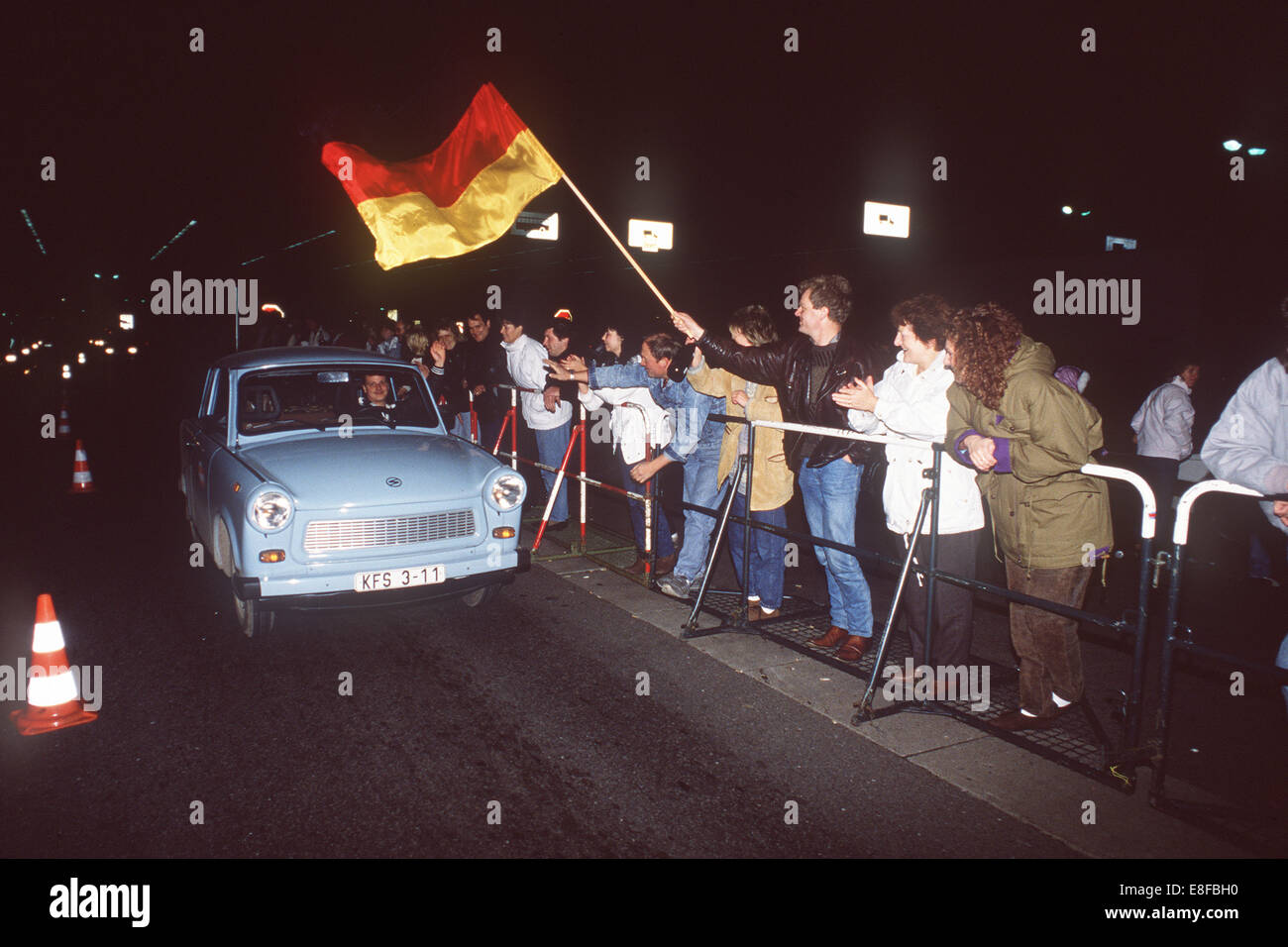 A driver of a Trabant from East Germany passes a border checking point ...
