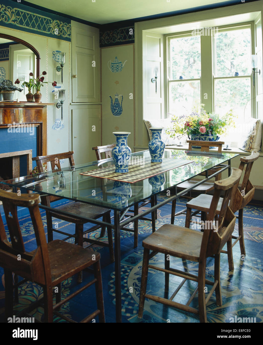 Old chapel chairs and glass topped table with blue+white vases in ...