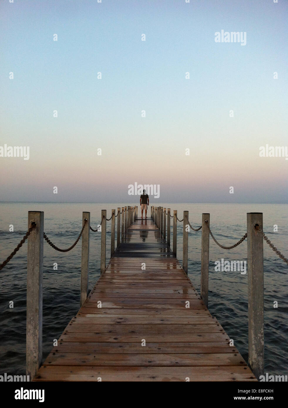 Man standing at the end of pier, Attica Periphery, Greece Stock Photo ...