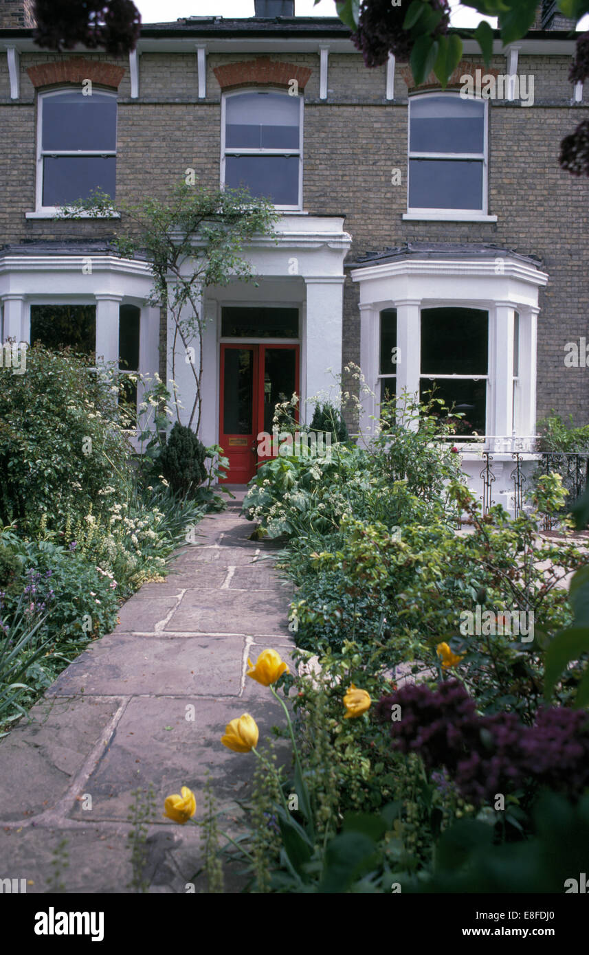 Front garden with stone flagged path to door of double fronted ...