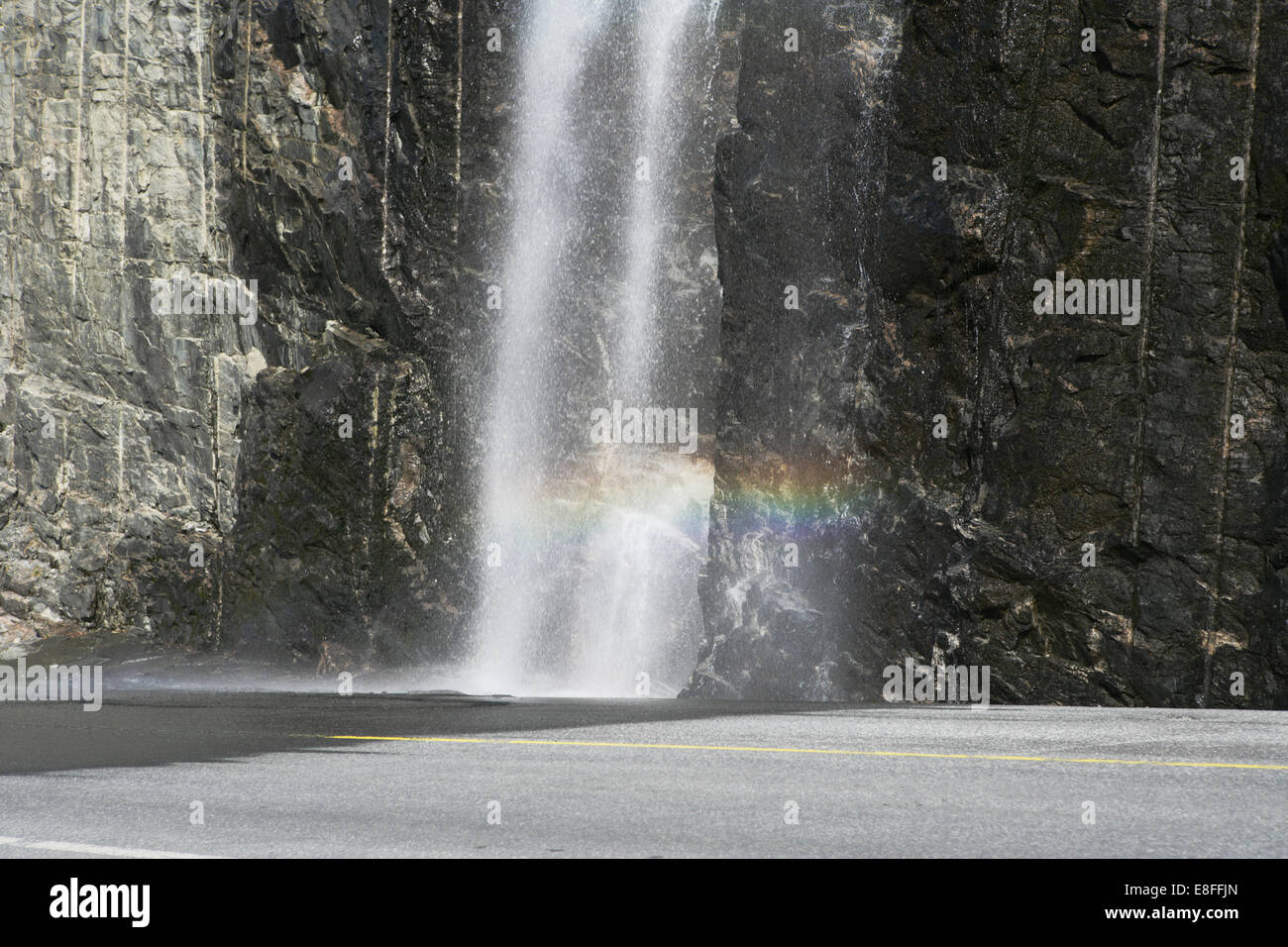 Rainbow in flowing water by road Stock Photo - Alamy