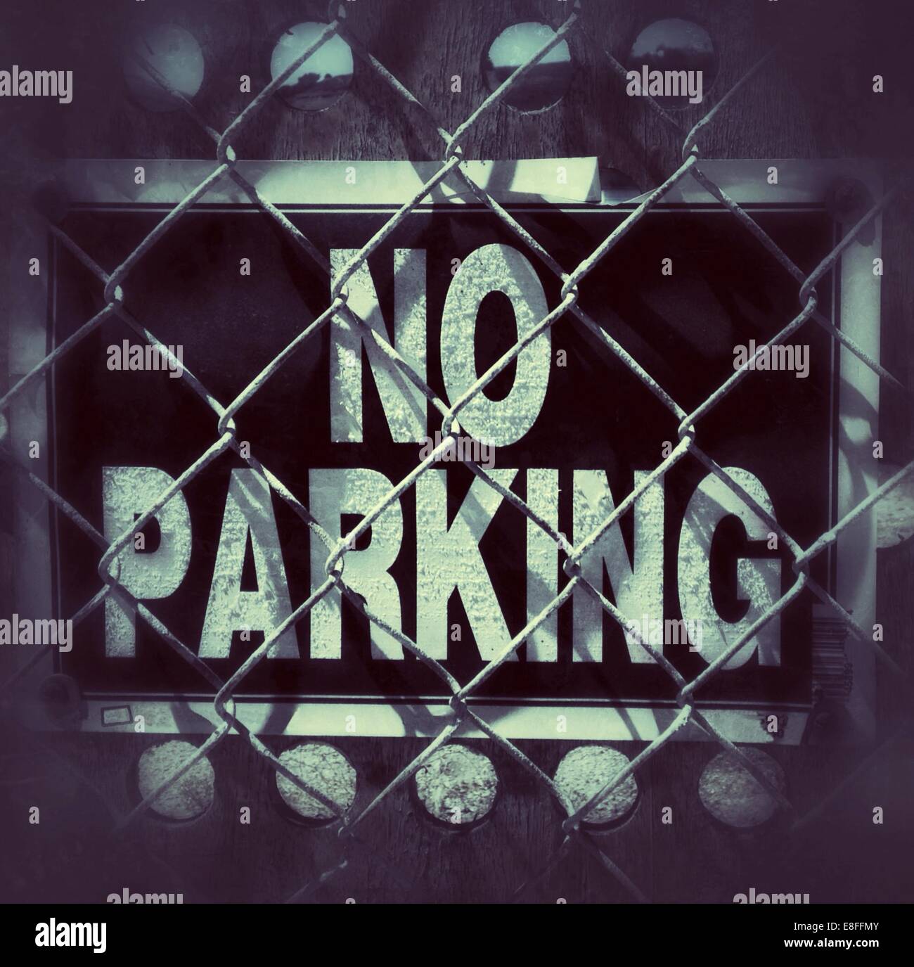 View of No parking sign behind chain link fence Stock Photo - Alamy