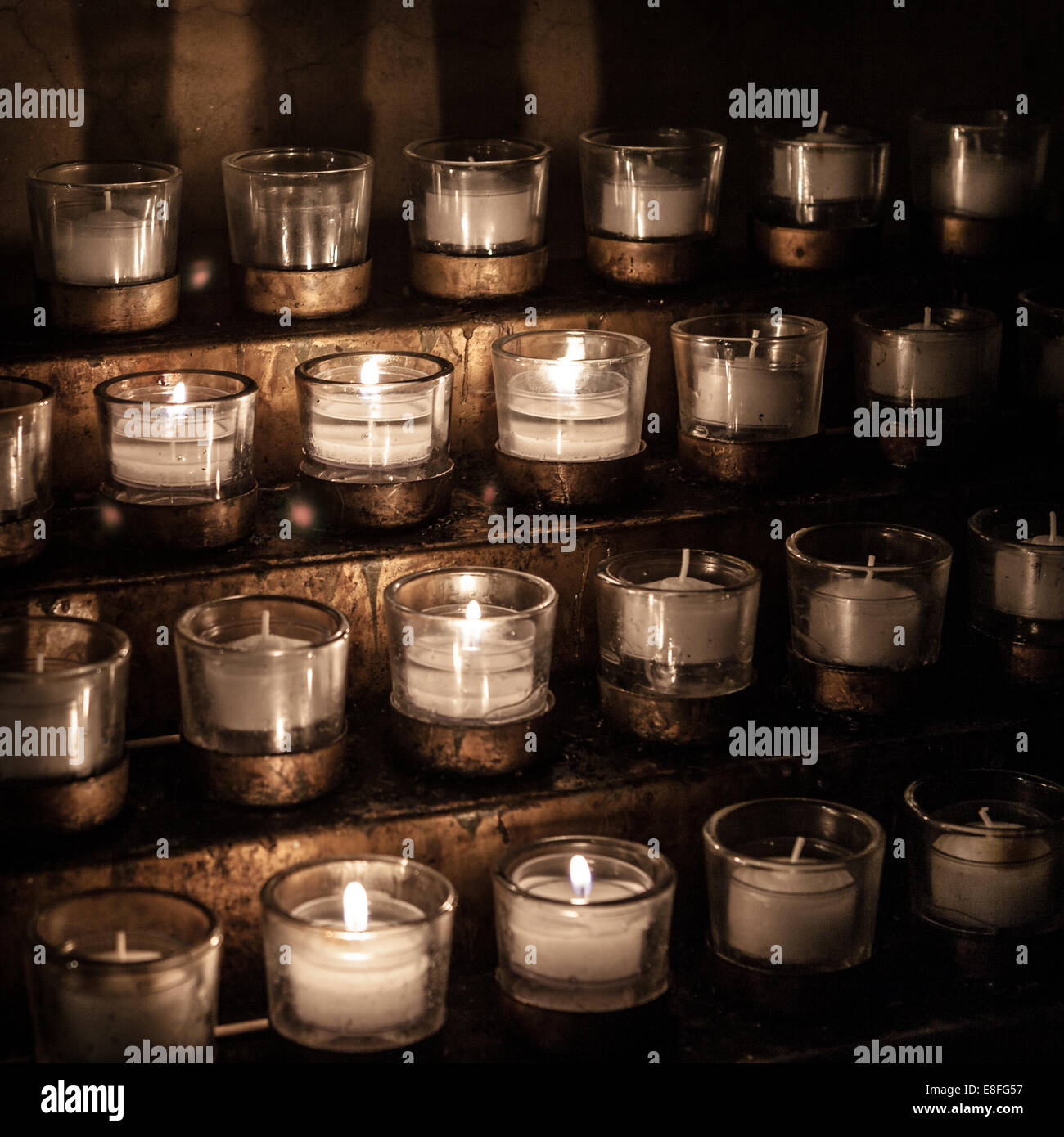 Rows of tea light candles in a church Stock Photo - Alamy