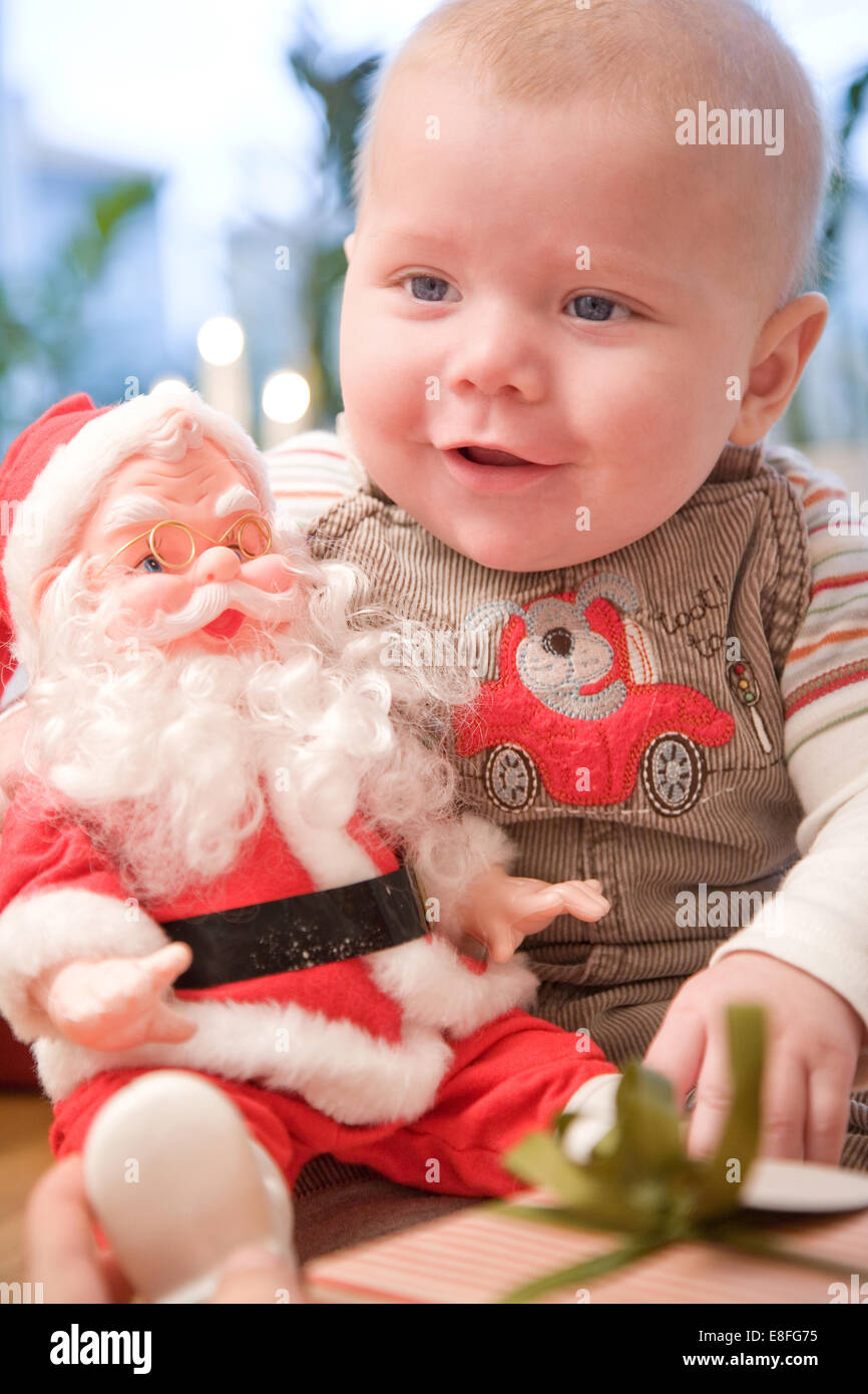 Baby boy with Father Christmas toy Stock Photo - Alamy