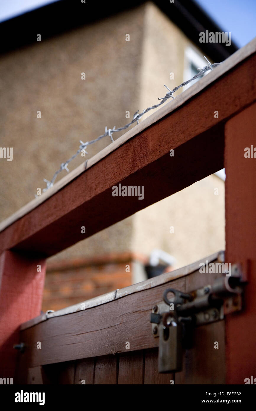 Barbed wire on top of a wooden gate Stock Photo - Alamy