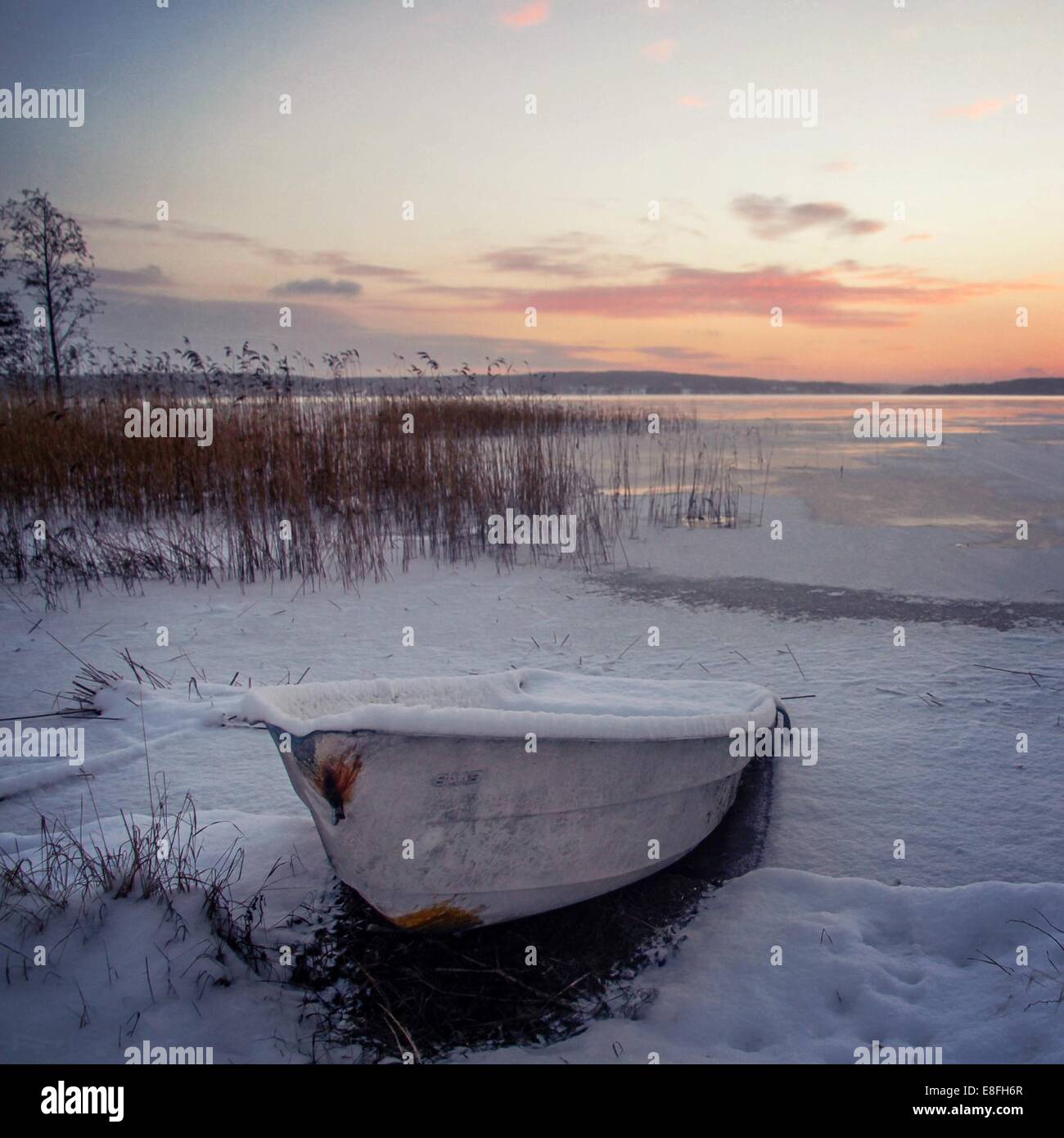 Snow covered rowing boat Stock Photo - Alamy
