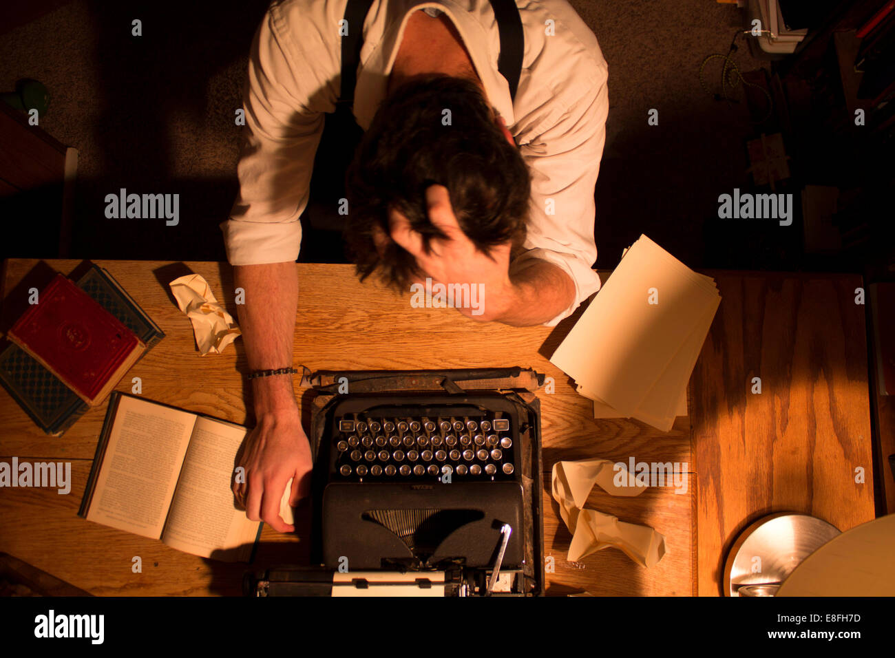 Man sitting at desk with writers block Stock Photo - Alamy